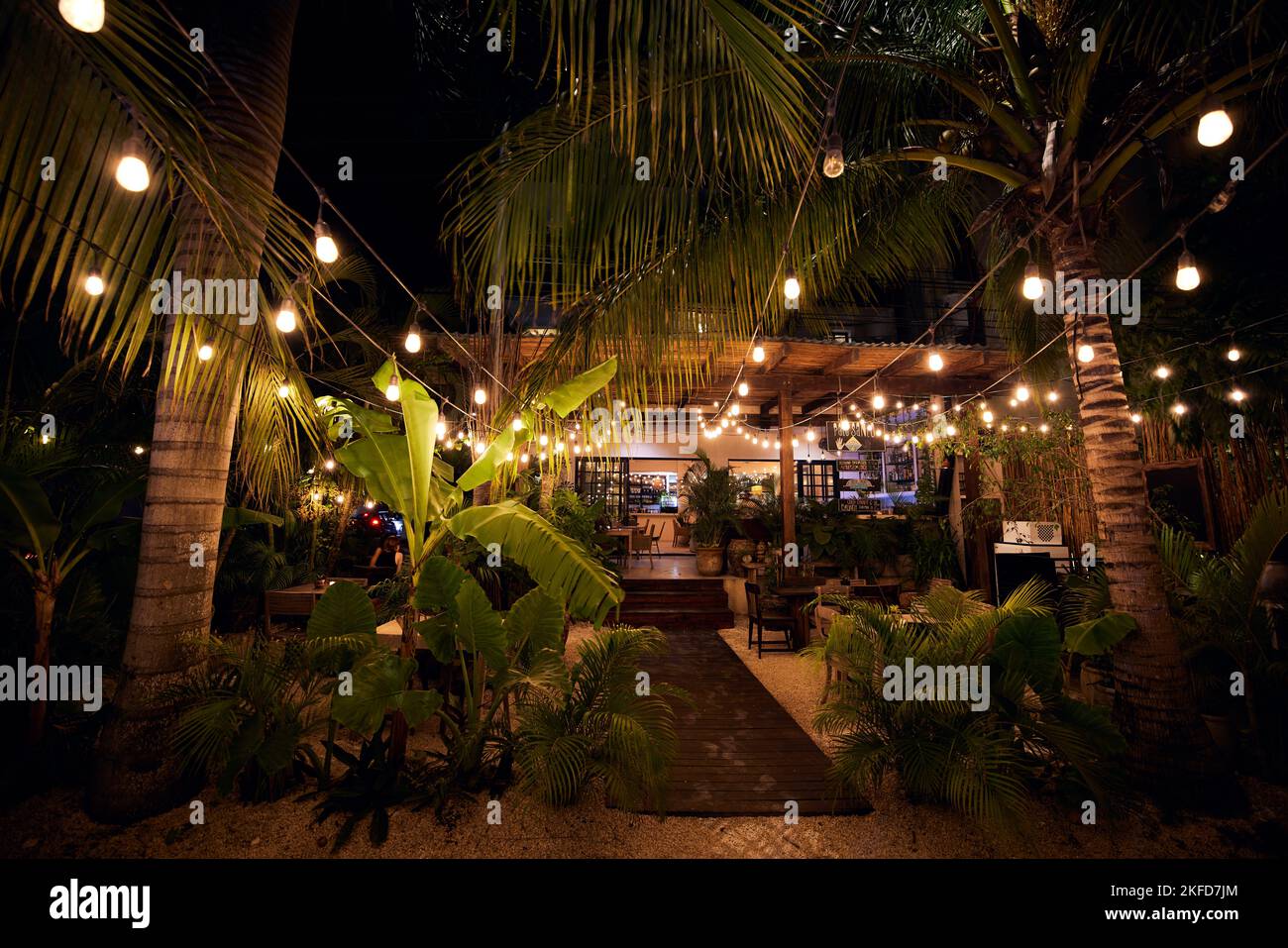 A restaurant with lights and palm trees in Tulum, Quintana Roo, Mexico ...