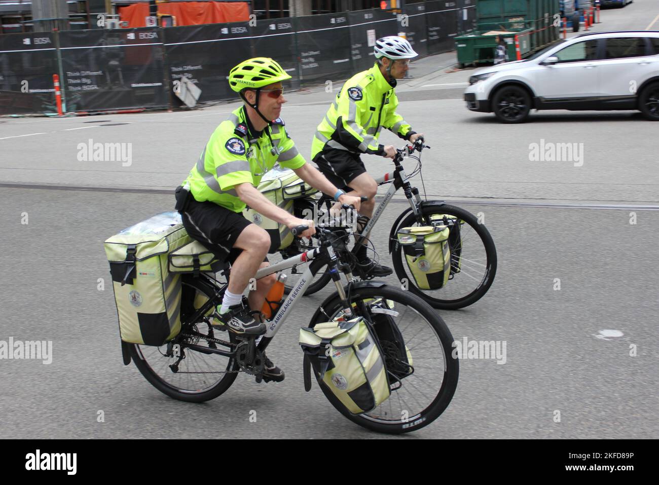 Paramedics riding bicycles in downtown Vancouver, British Columbia ...