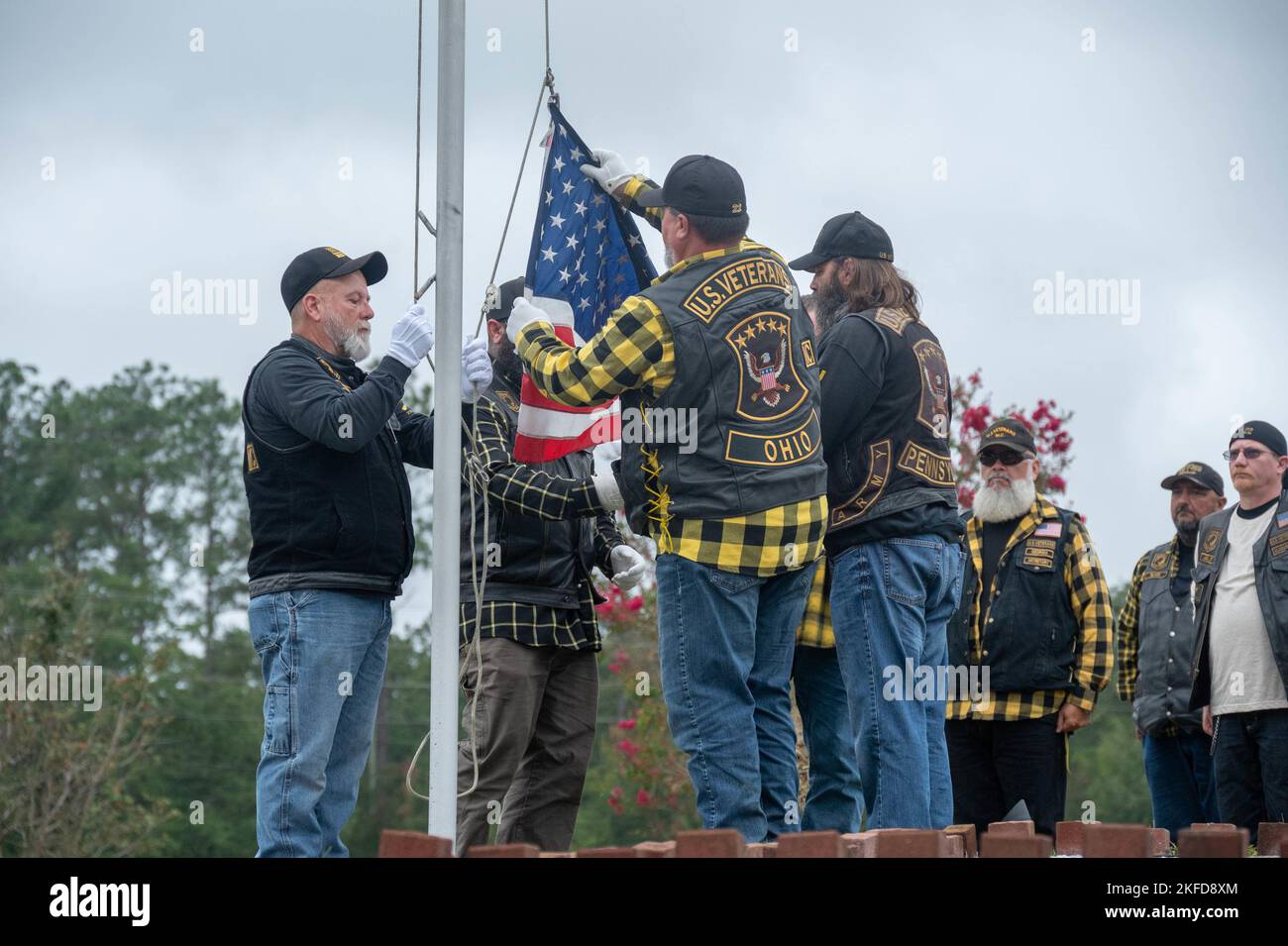 Members of the U.S. Veterans Motorcycle Club raise a flag at the World ...