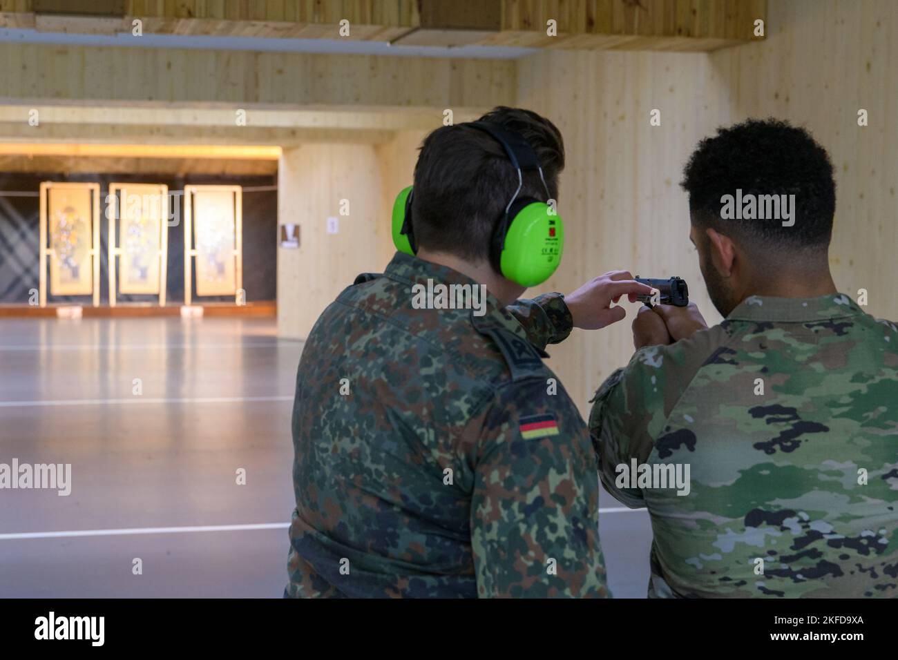 A German range safety coaches U.S. Army Sgt. Julian Daniels, with 39th ...