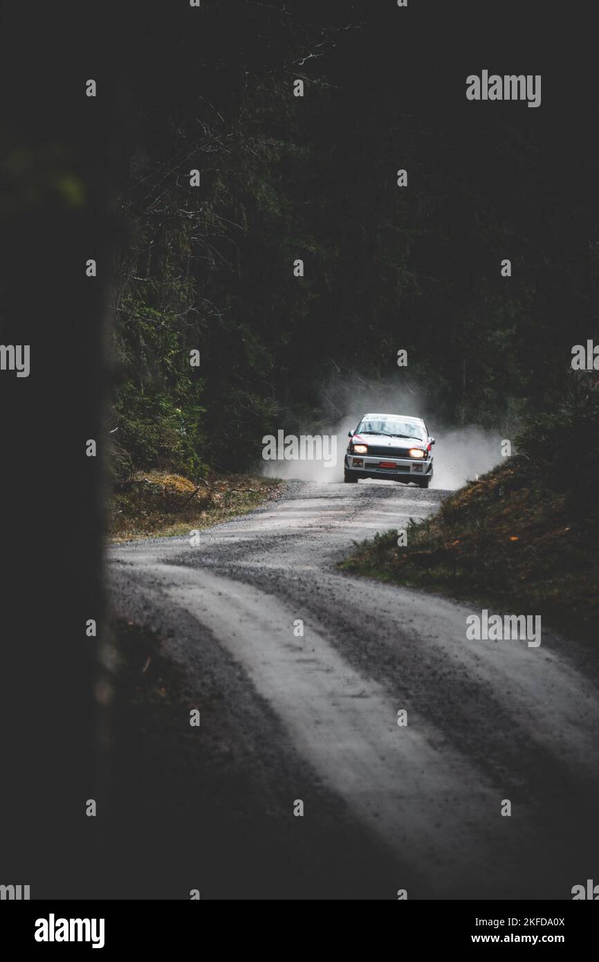 A car driving on a dirt path during a rally event in Nybro, Sweden ...