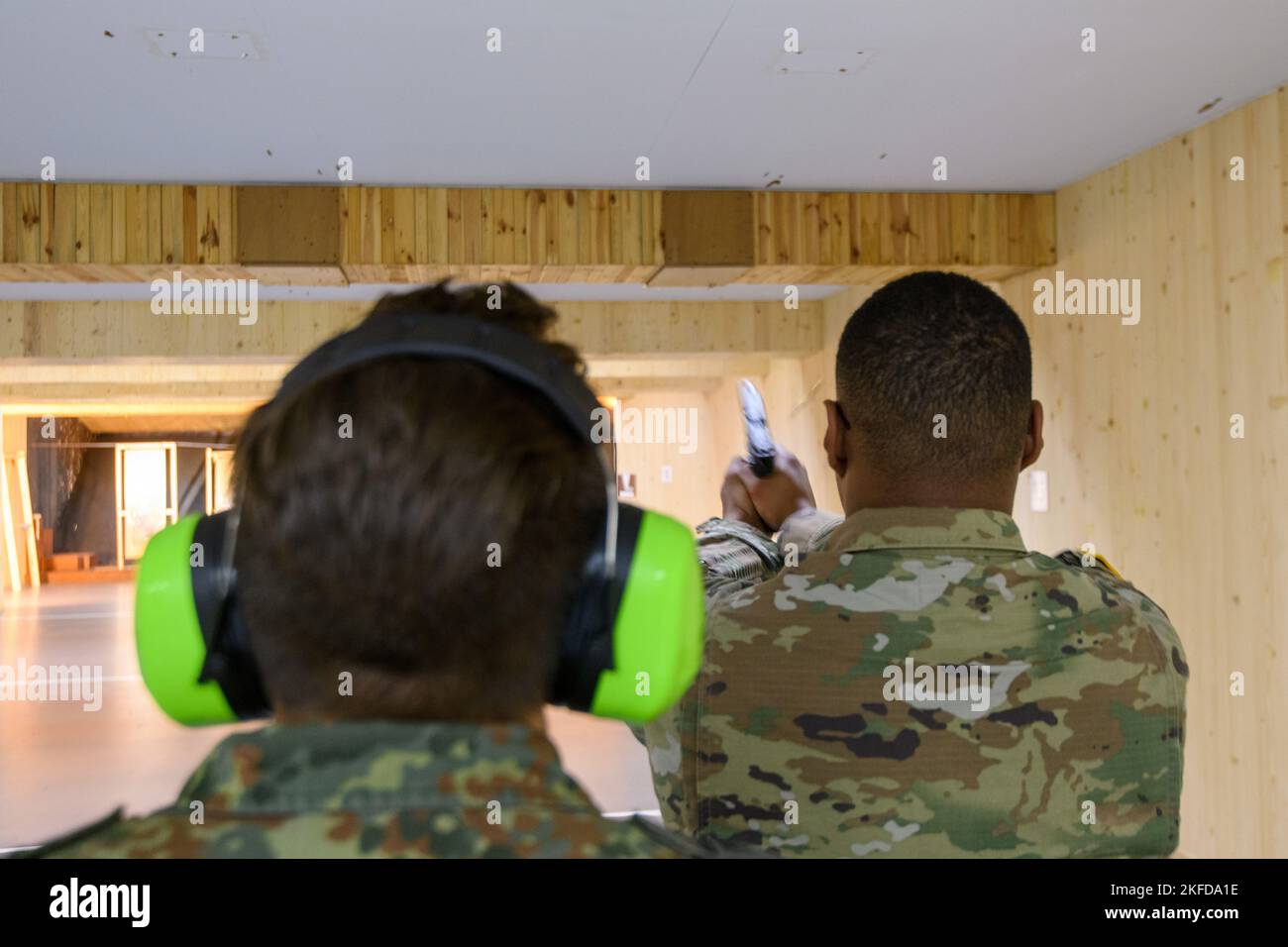 A German range safety watches as a U.S. Soldier fires with the German ...