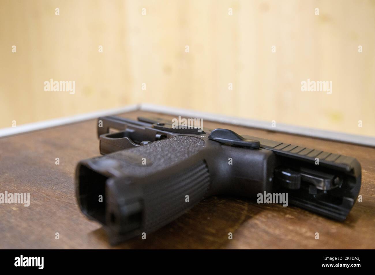 A Heckler and Koch P8 pistol lays on a table as U.S. Soldiers compete ...
