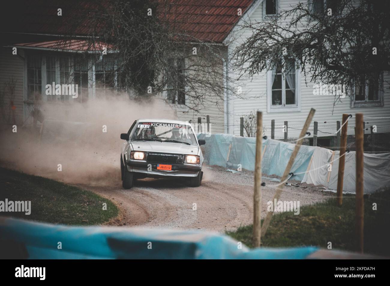 A vintage racing car surrounded by dust and smoke at the Zabra Rally in ...