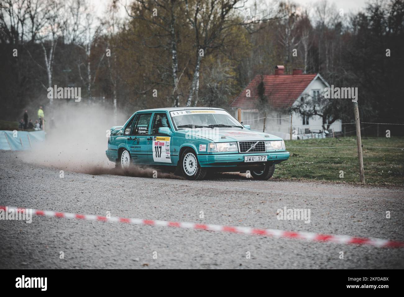 A vintage racing car surrounded by dust and smoke at the Zabra Rally in ...