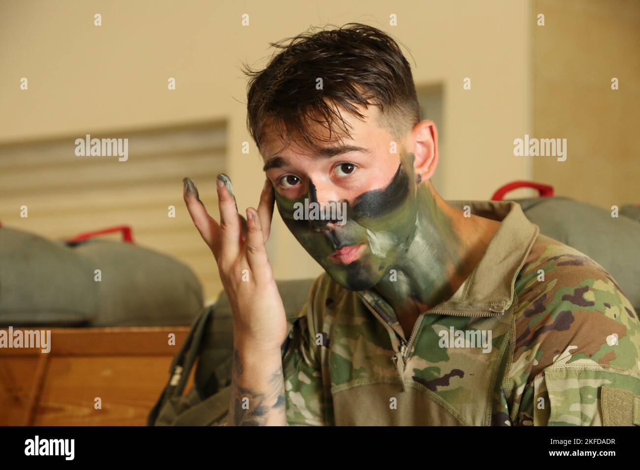 Spc. Devin Lowney of the 173rd Airborne Brigade applies camo paint in ...