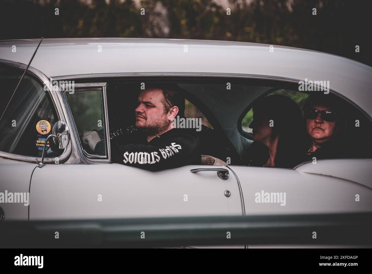The people in a white retro car at a cruising event with old and great ...