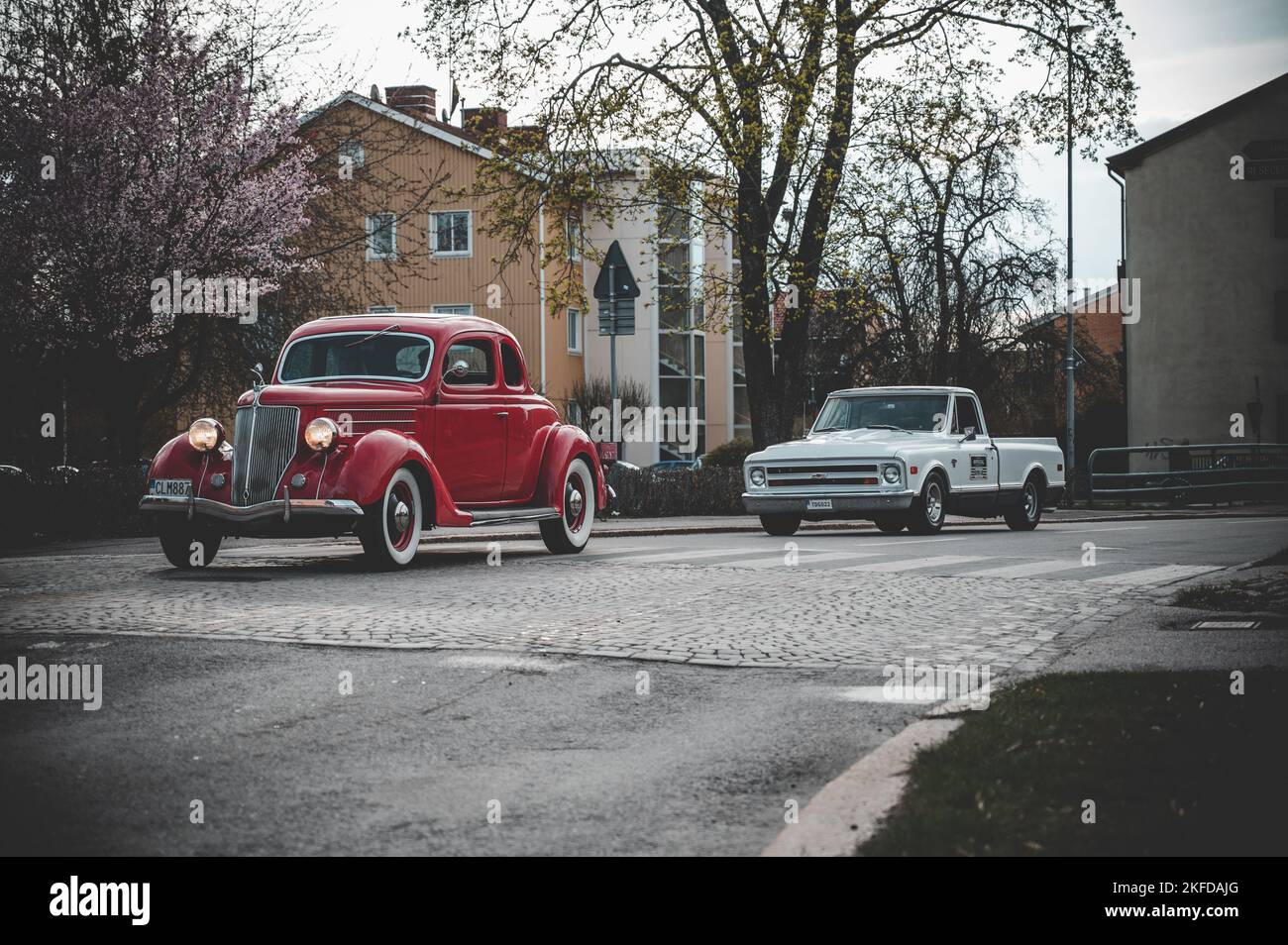 Old cars red Ford Model 48 and Chevrolet CK Cruising in the city ...