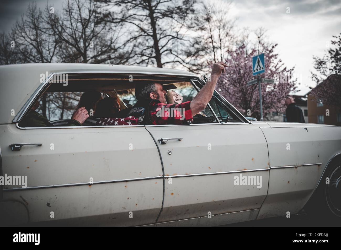 The people in a white retro car at a cruising event with old and great ...
