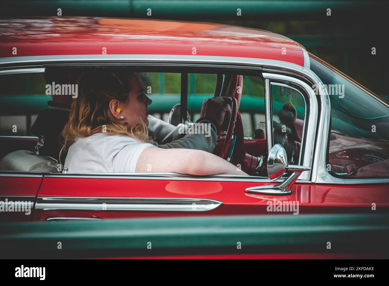 The people in a red retro car at a cruising event with old and great ...