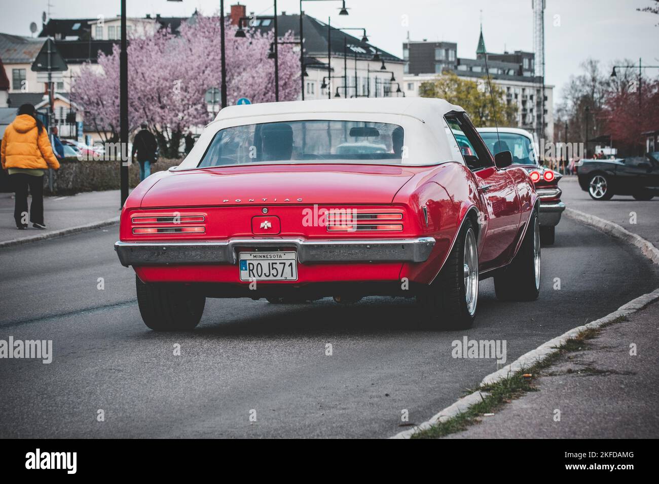 A vintage red car during a cruising event on a city road Stock Photo ...