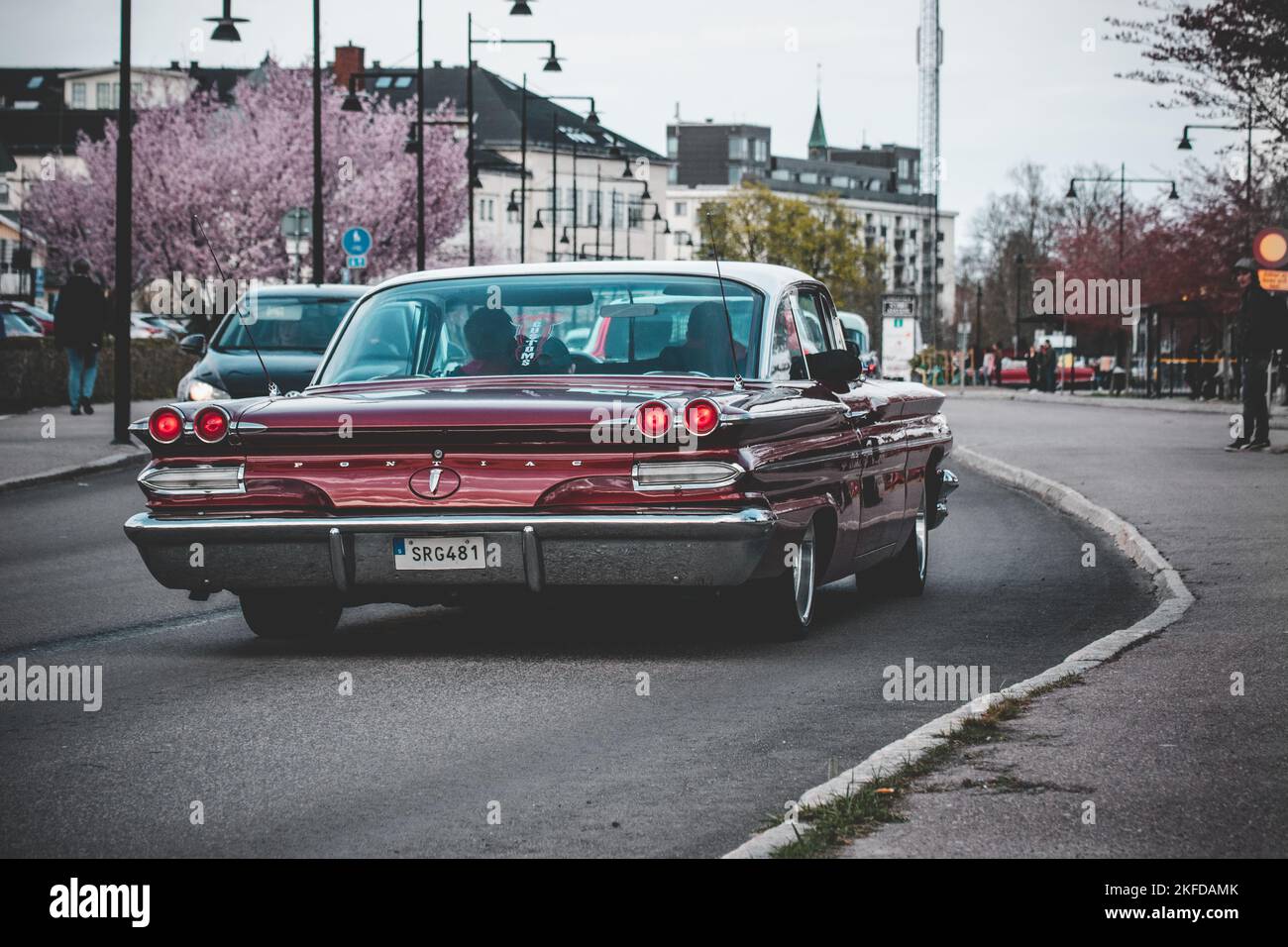 A vintage red car during a cruising event on a city road Stock Photo ...