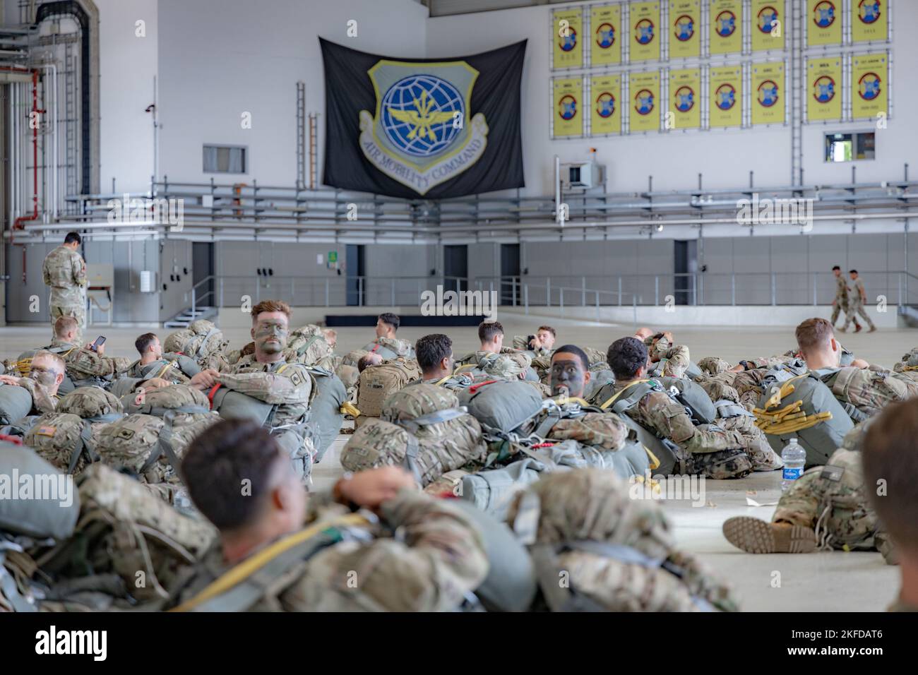 U.S. Army soldiers assigned to the 173rd Airborne Brigade wait to load ...