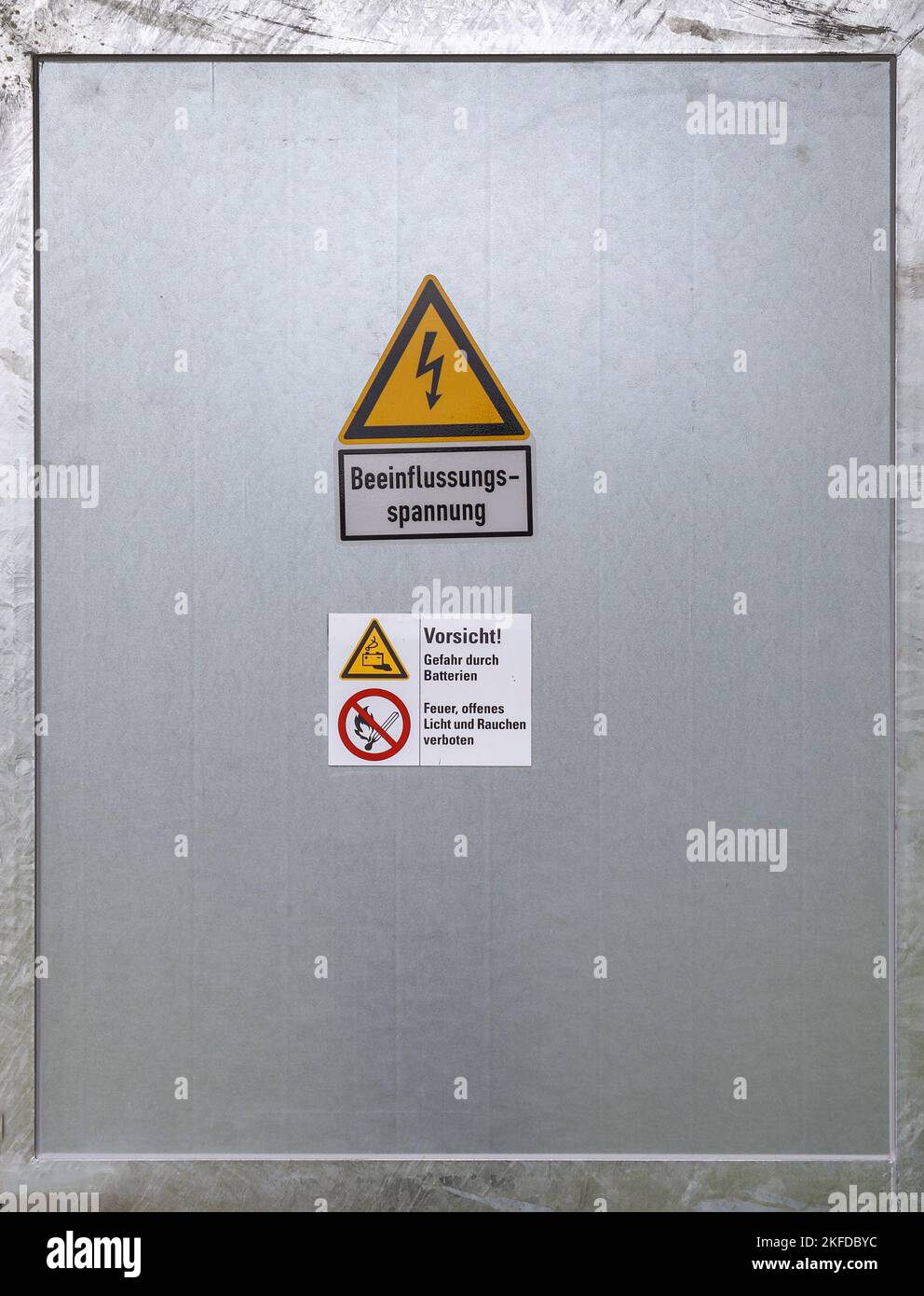 A metal door with German warning signs against electrical high voltage ...