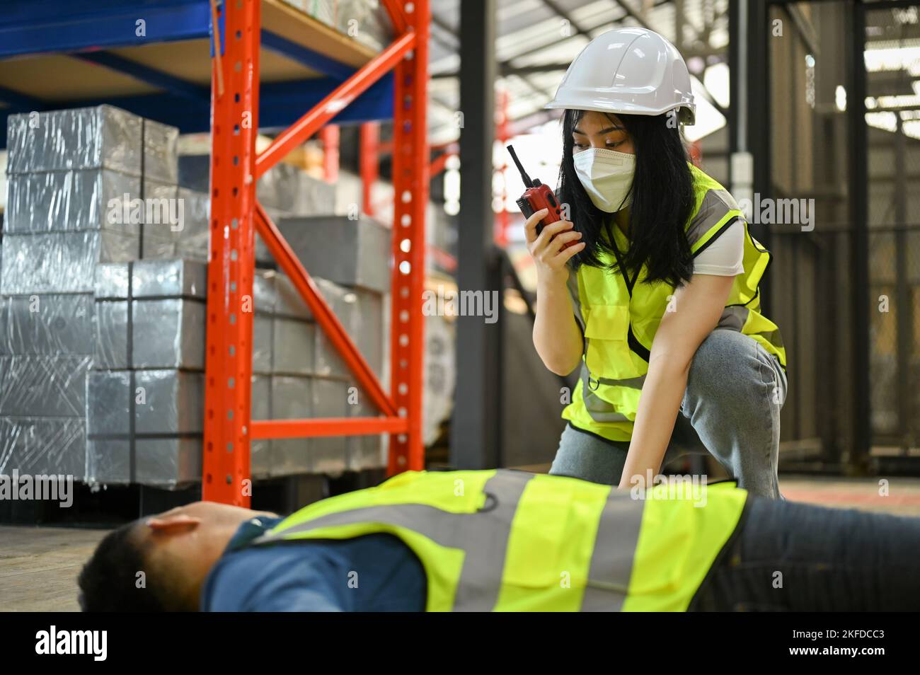 A female warehouse worker using a walkie-talkie called the factory's ...