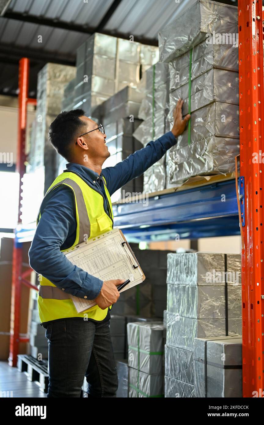 Portrait, Professional and happy millennial Asian male warehouse worker ...