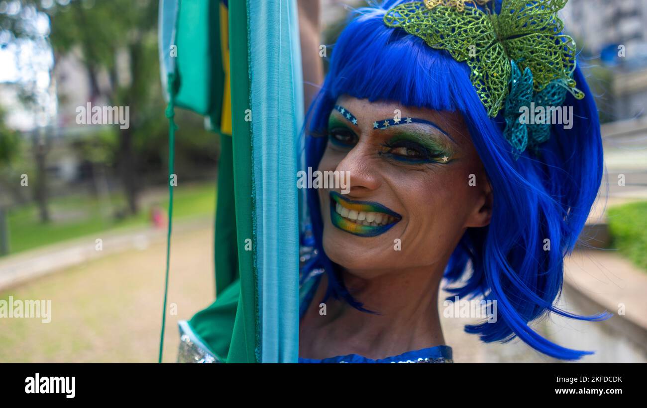 Dragqueen in her green and yellow outfit and makeup cheering during the ...