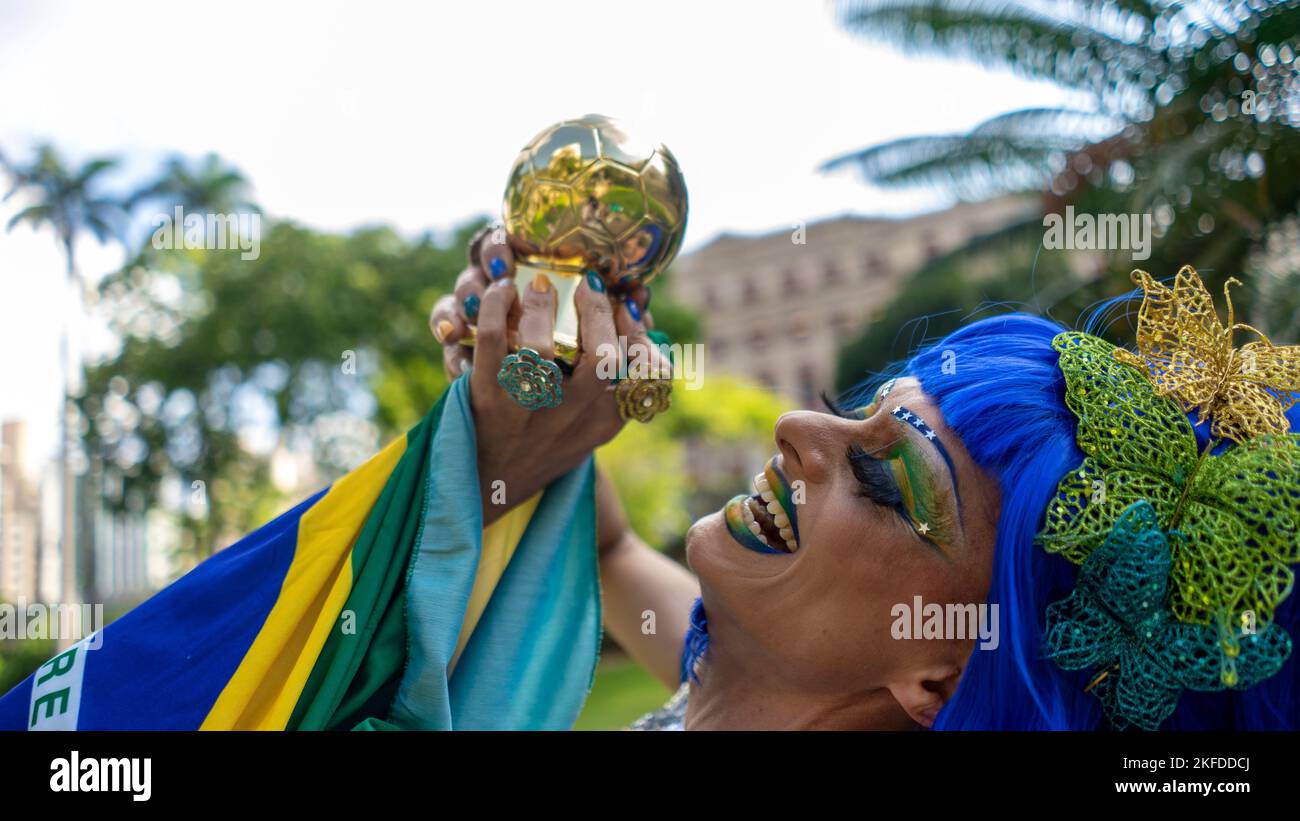 Dragqueen in her green and yellow outfit and makeup cheering during the ...