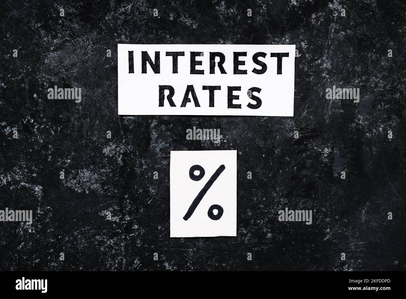 Interest rates text with percentage symbol on dark background, concept ...