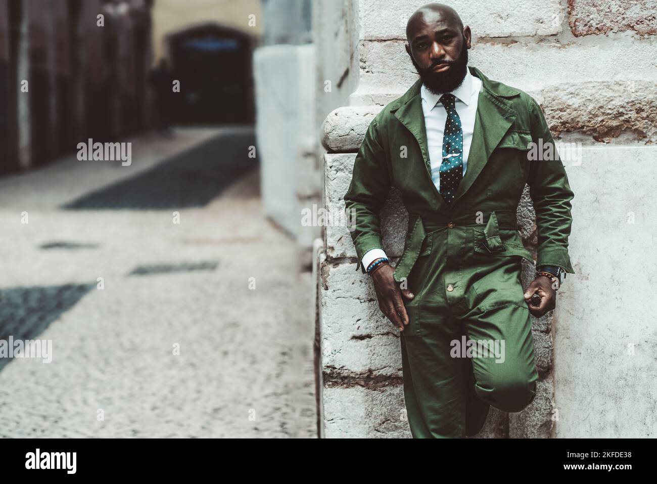 A dapper tough bald bearded handsome black guy in a fashionable ...