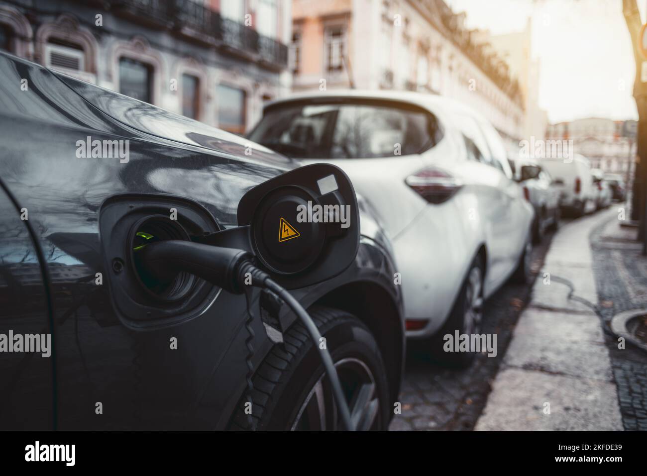 A wide-angle close-up shot of a thick black power cable inserted into ...
