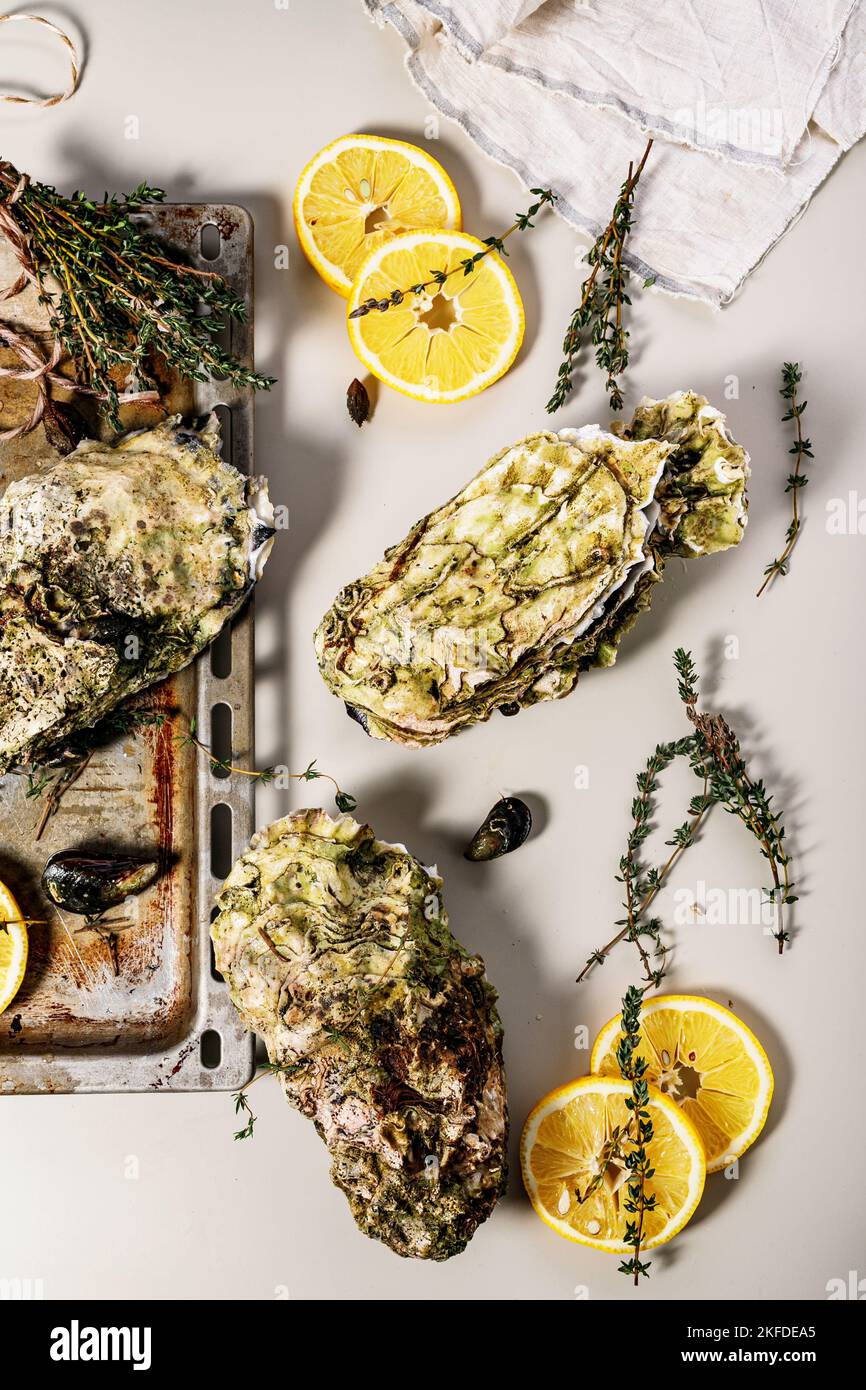 Top view Giant Fresh Pacific Oysters on a light background. Lemon and ...