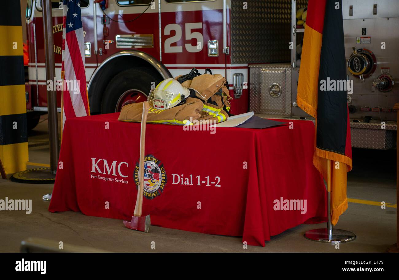 A display of a firefighter’s uniform and an ax rest on a table are ...