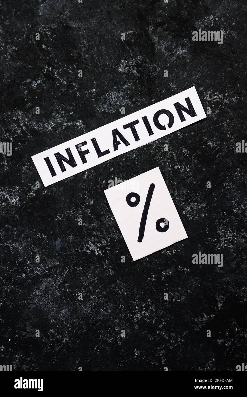 Inflation text with percentage symbol on dark background, concept of ...