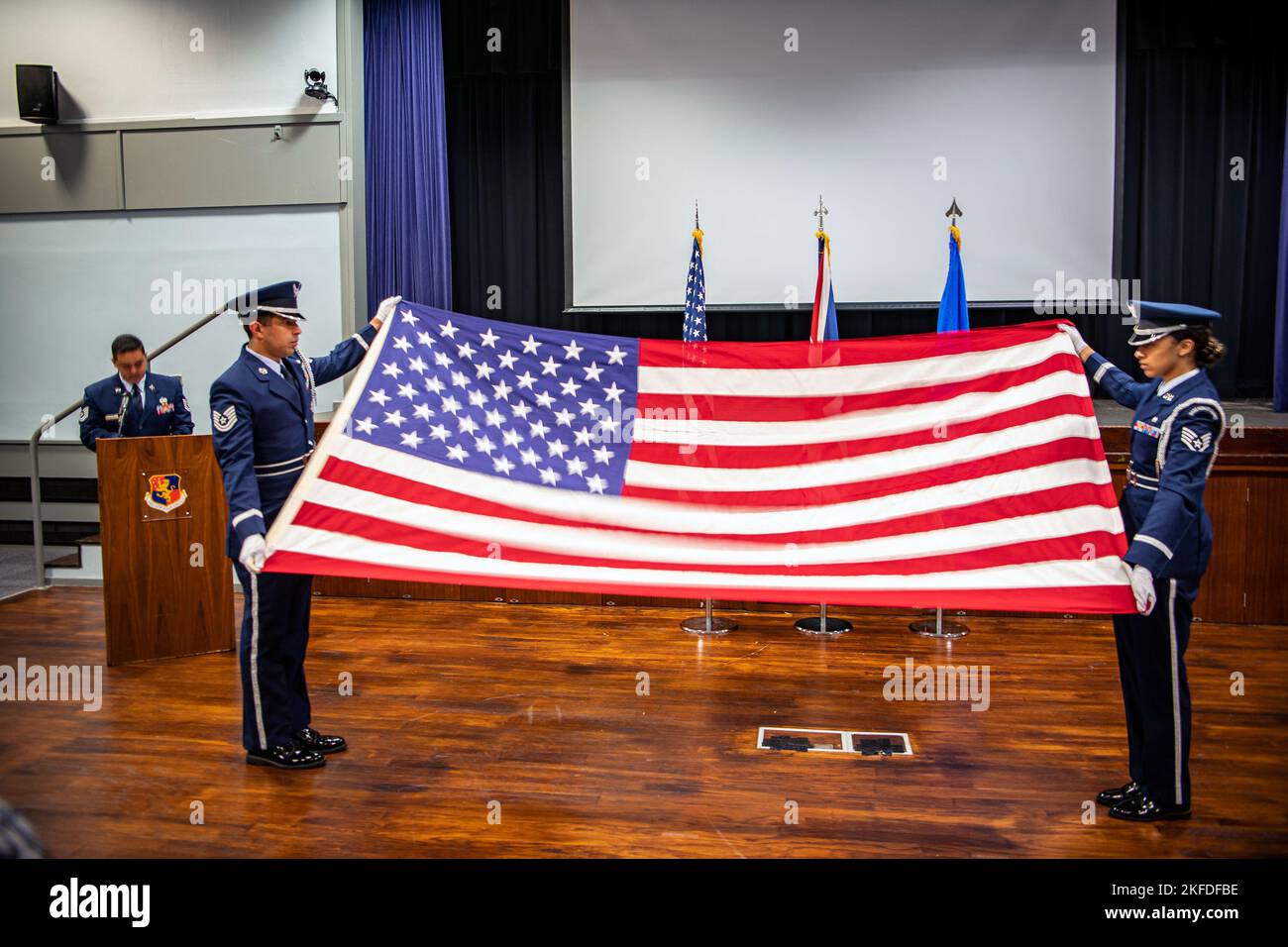 Airmen from the 422d Air Base Group honor guard, hold a flag at the ...