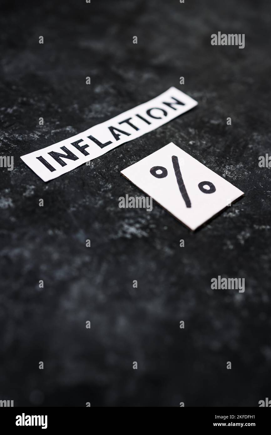 Inflation text with percentage symbol on dark background, concept of ...