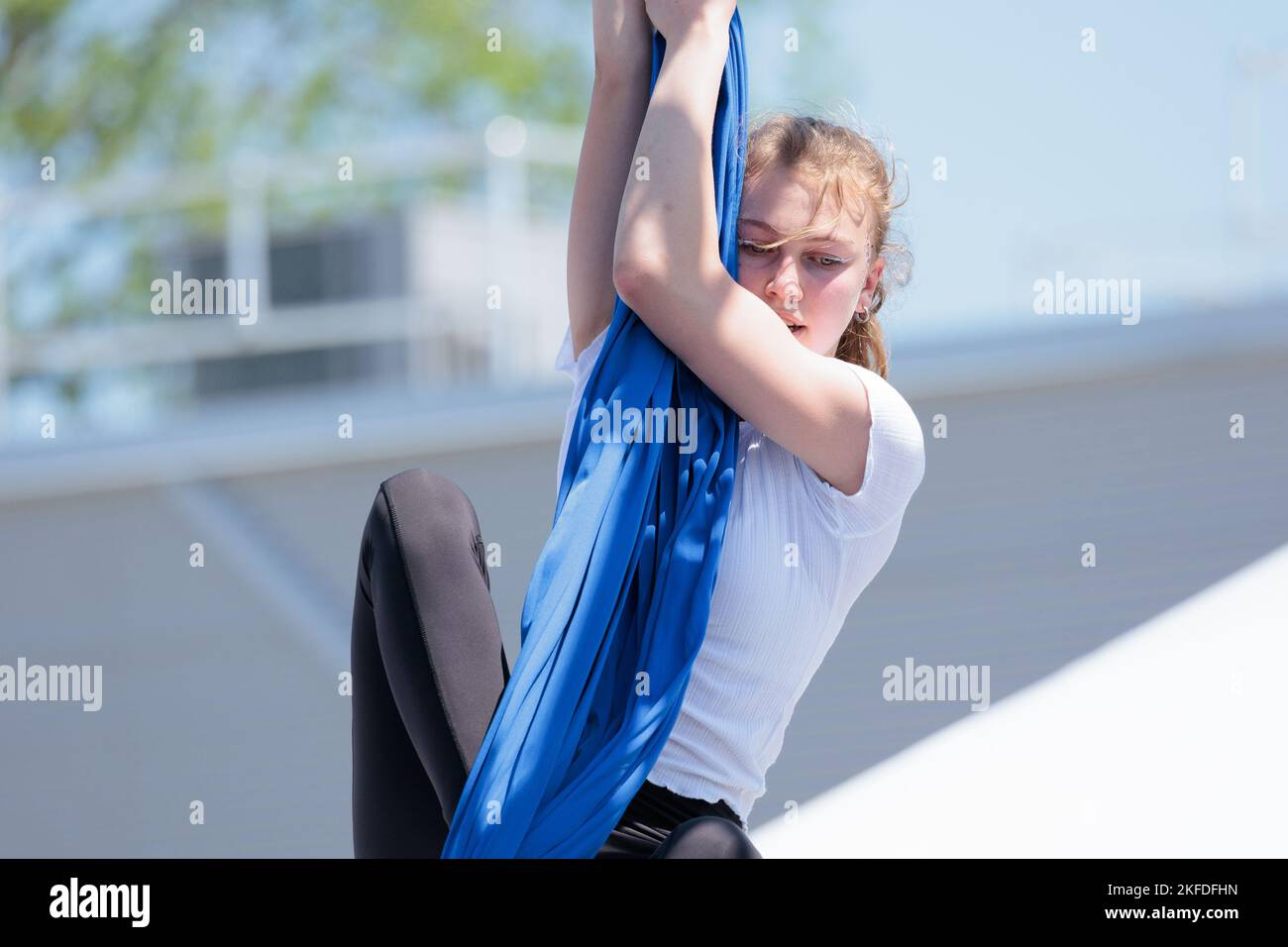 A female acrobat perform outdoors to the delight of the crowd at Cirque ...