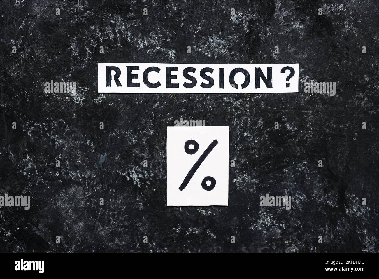 Recession text with question mark and percentage symbol on dark ...