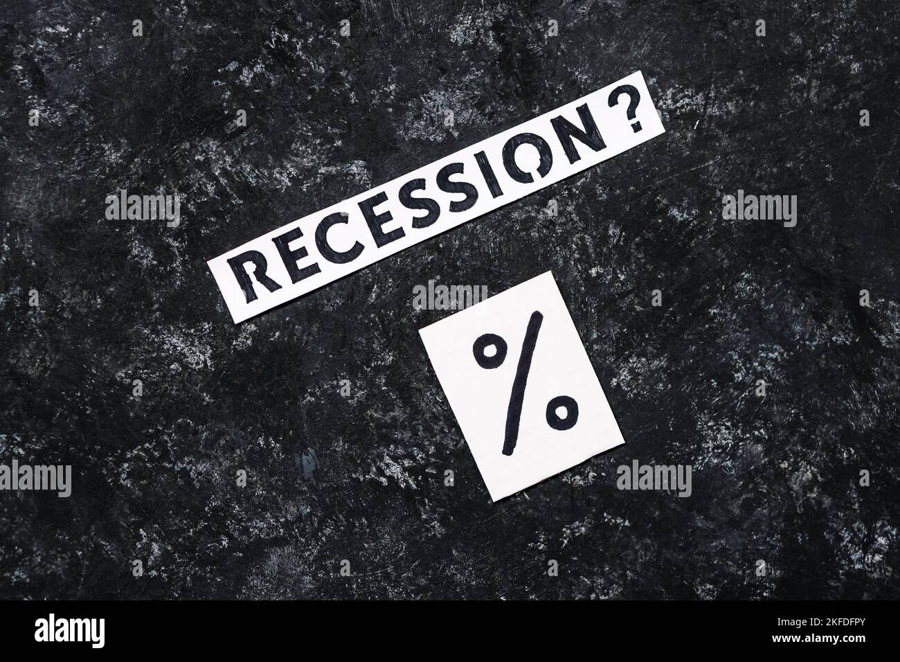 Recession text with question mark and percentage symbol on dark ...