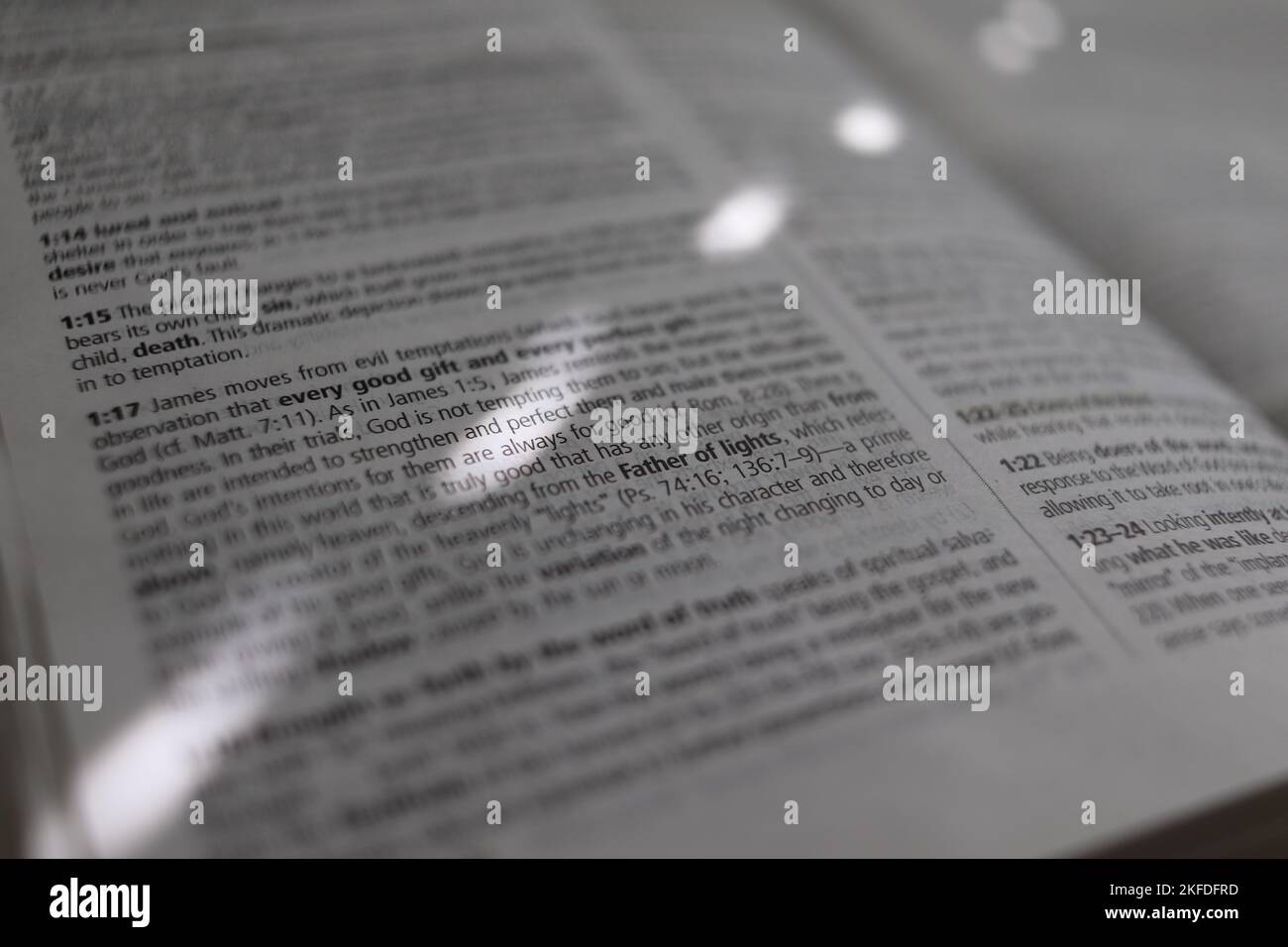 A closeup of a Bible text with sunlight, the holy book of Christianity ...