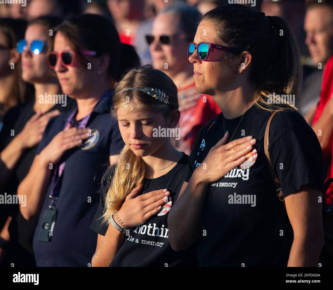 Misty Perry and her daughter, Kylynn, 11, place their hands over their ...
