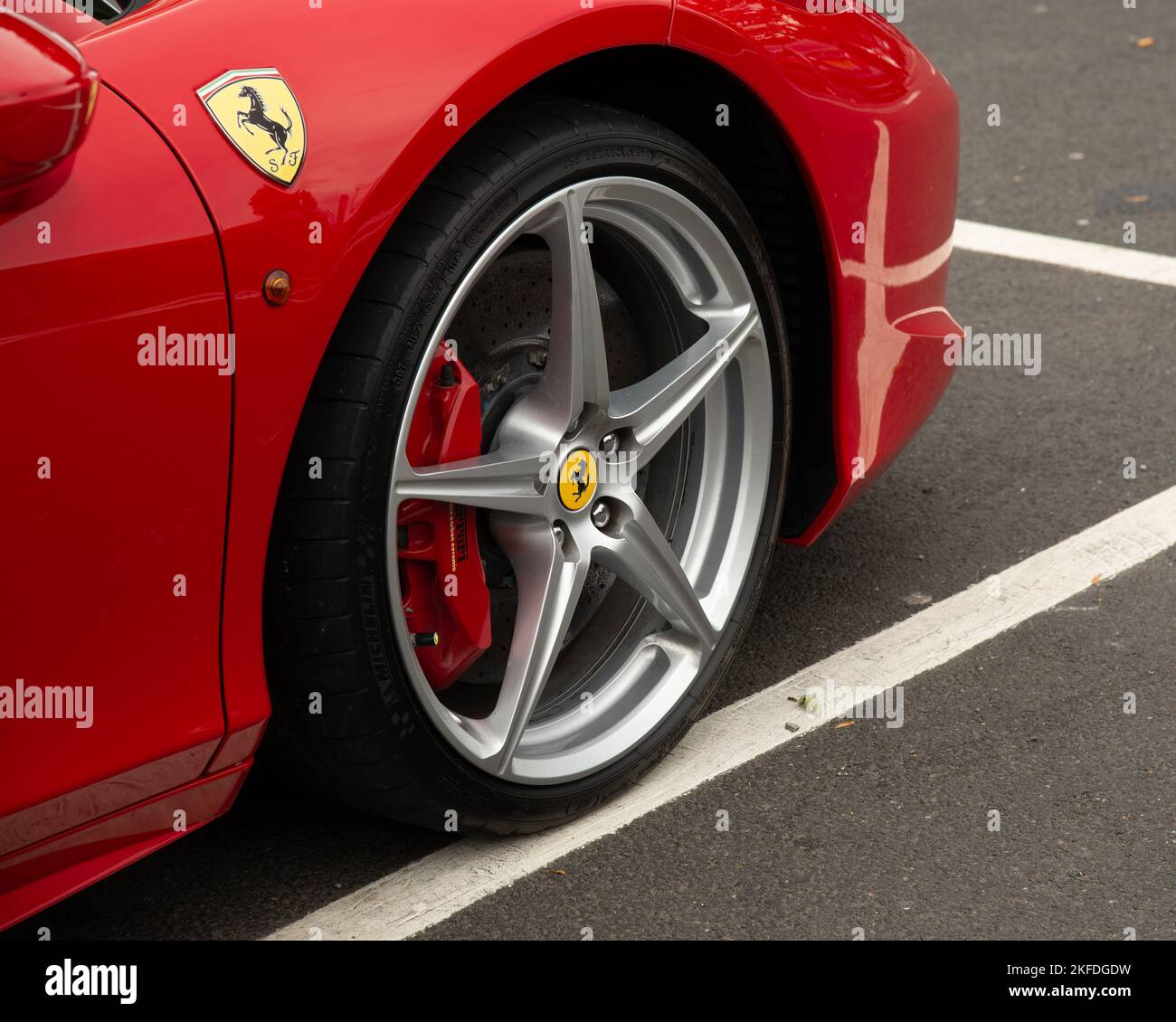 A close-up shot of the tire of the luxury Italian red Ferrari in the ...