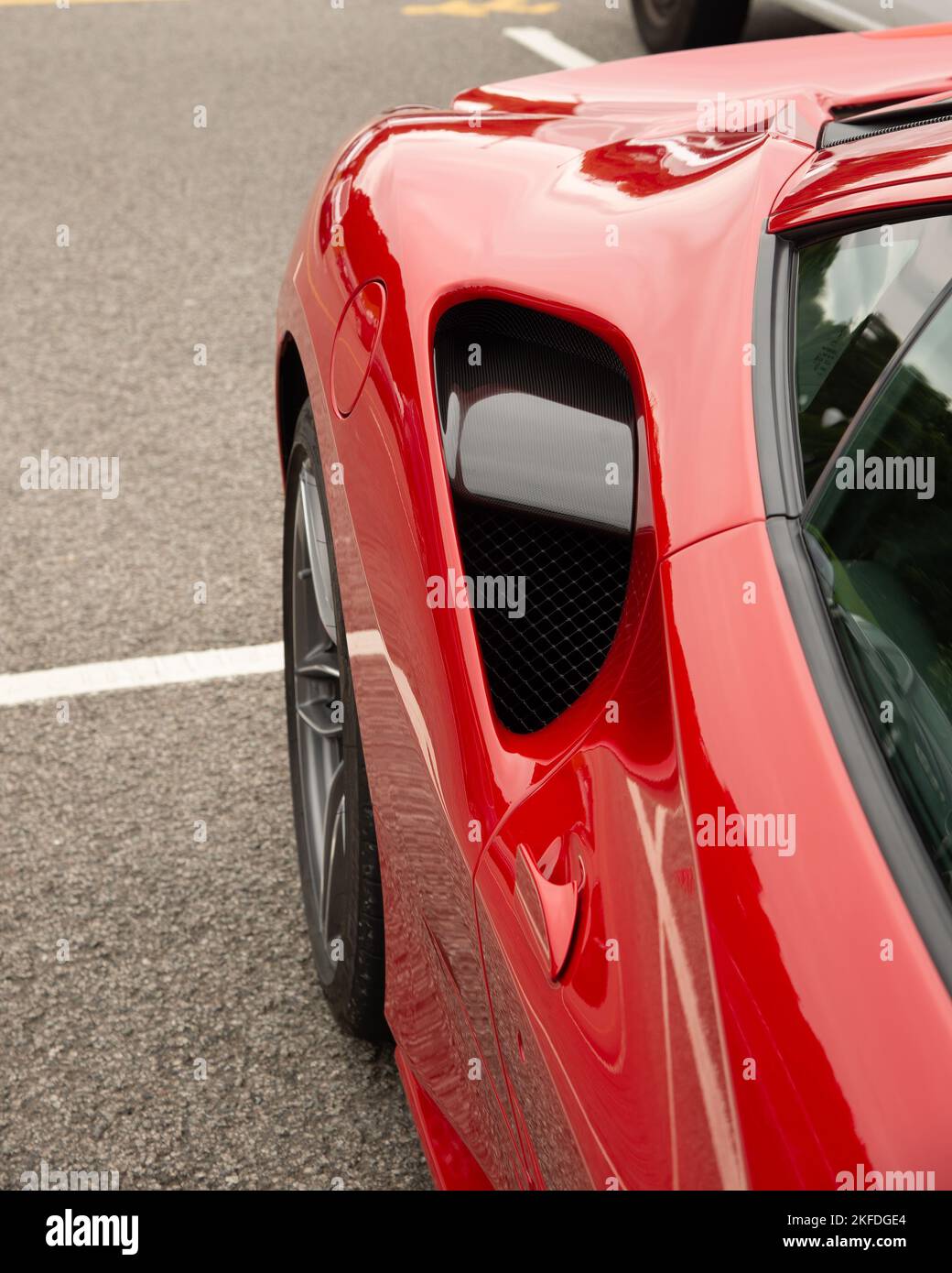 A vertical shot of the front part of the Luxury Italian red Ferrari ...