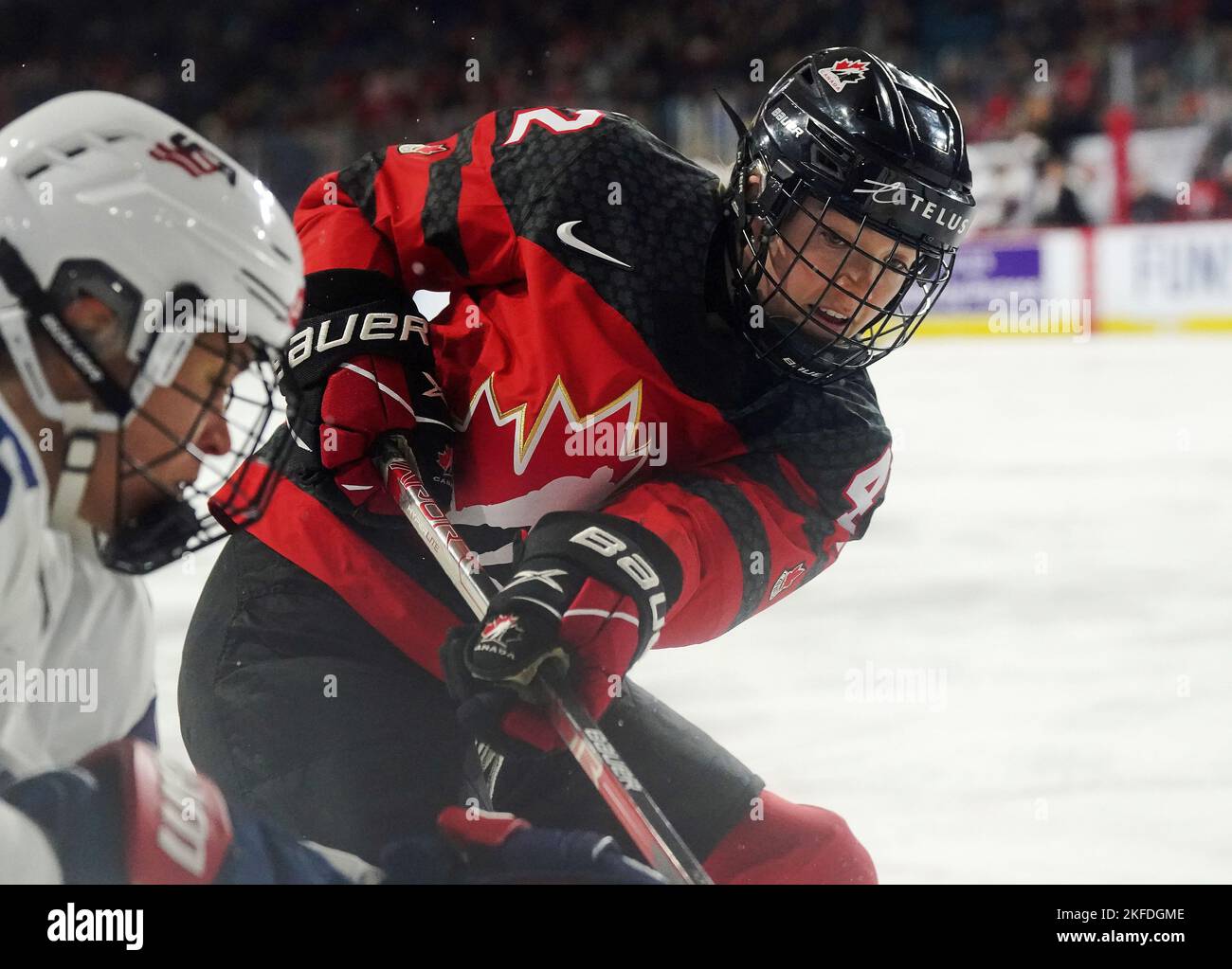 Canada's Claire Thompson (42) battles along the boards against the ...