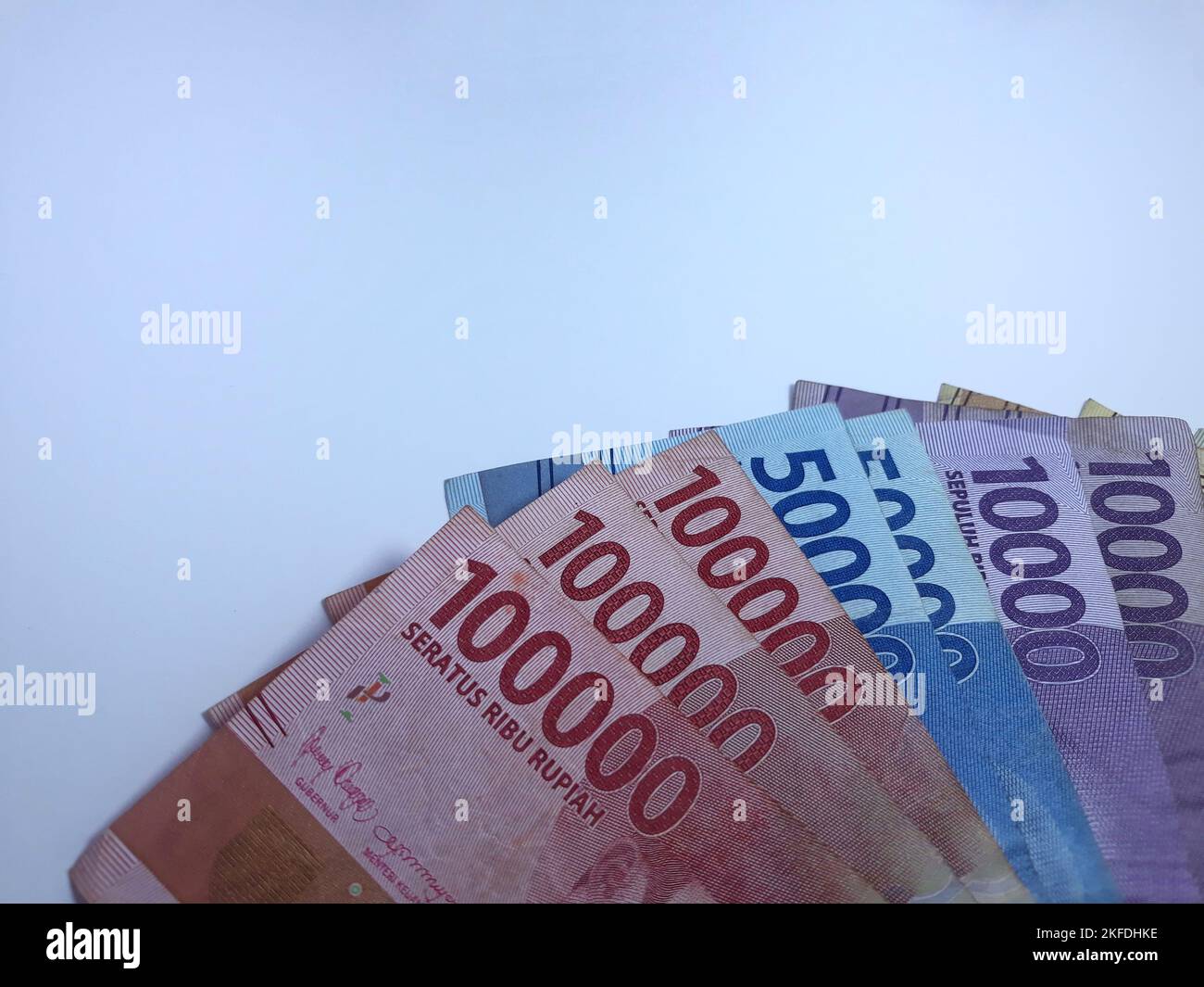 Close up isolated on white money several banknotes denominated in ...