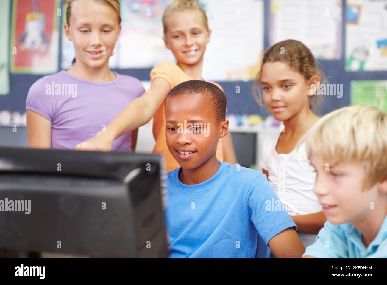 Enjoying the internet with friends. A group of young school kids ...