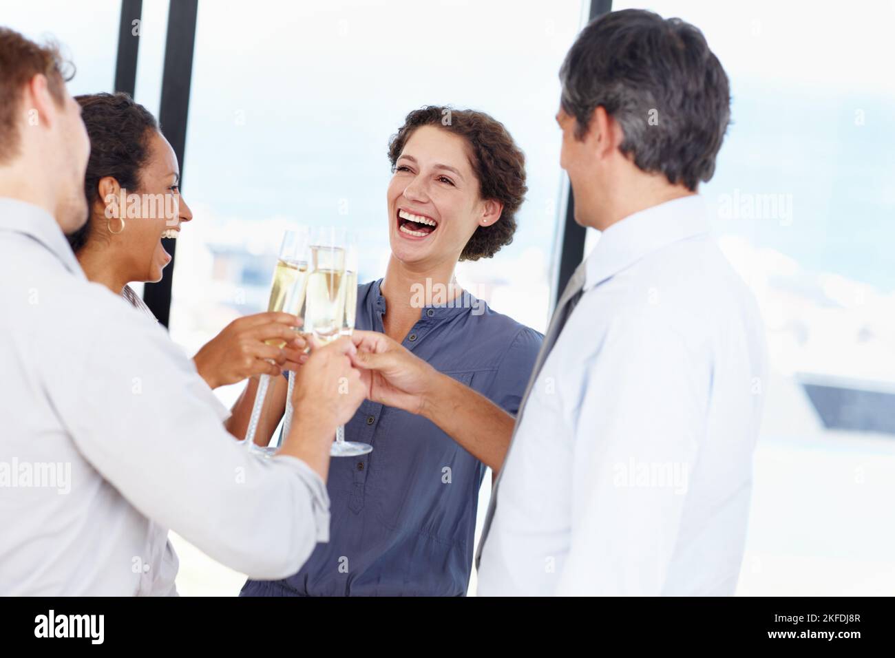 Celebrating their companys success. a group of businesspeople toasting ...