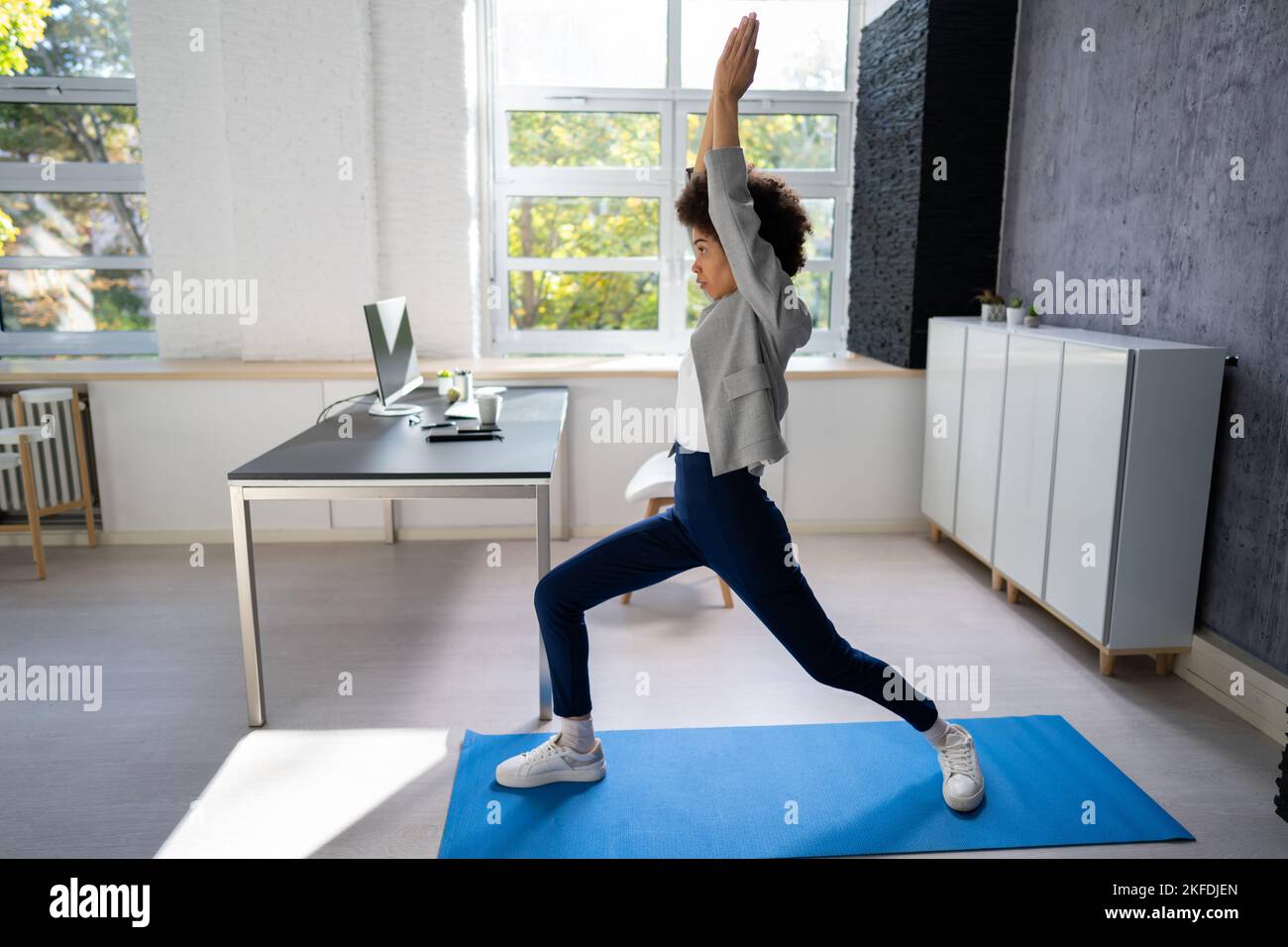 Corporate Employee Woman Standing Doing Fitness And Yoga Stock Photo ...