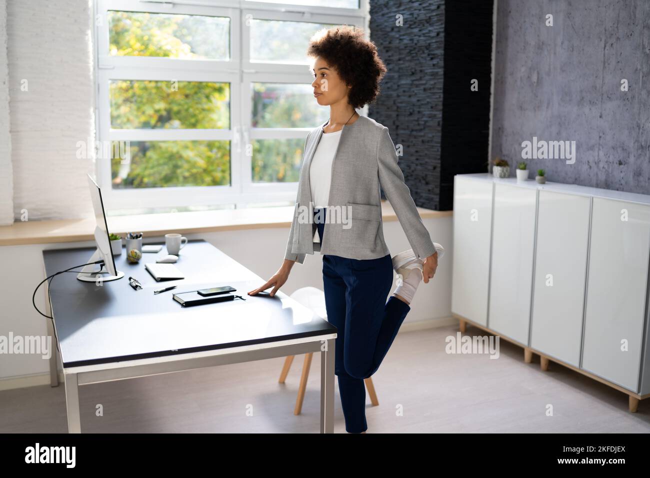 Woman standing behind desktop hi-res stock photography and images - Alamy