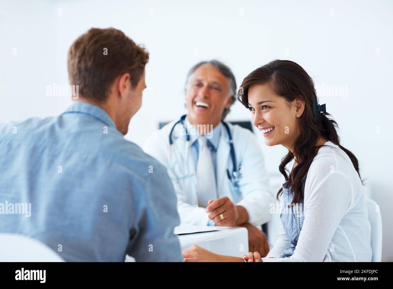 Mature doctor and patients having a healthy conversation. Portrait of ...