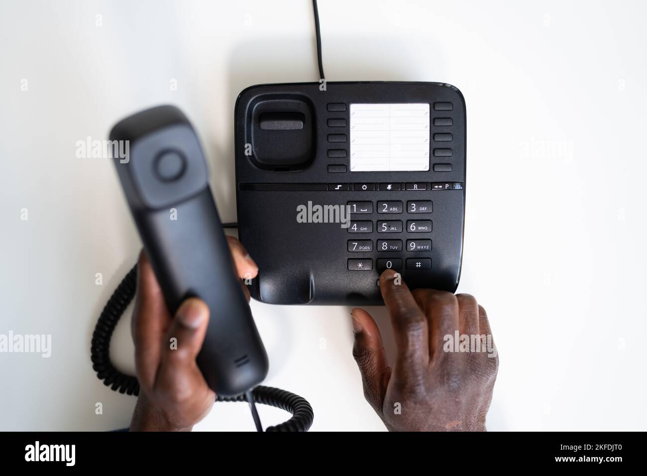 Businessman's Hand Dialing Telephone Number To Make Phone Call In ...