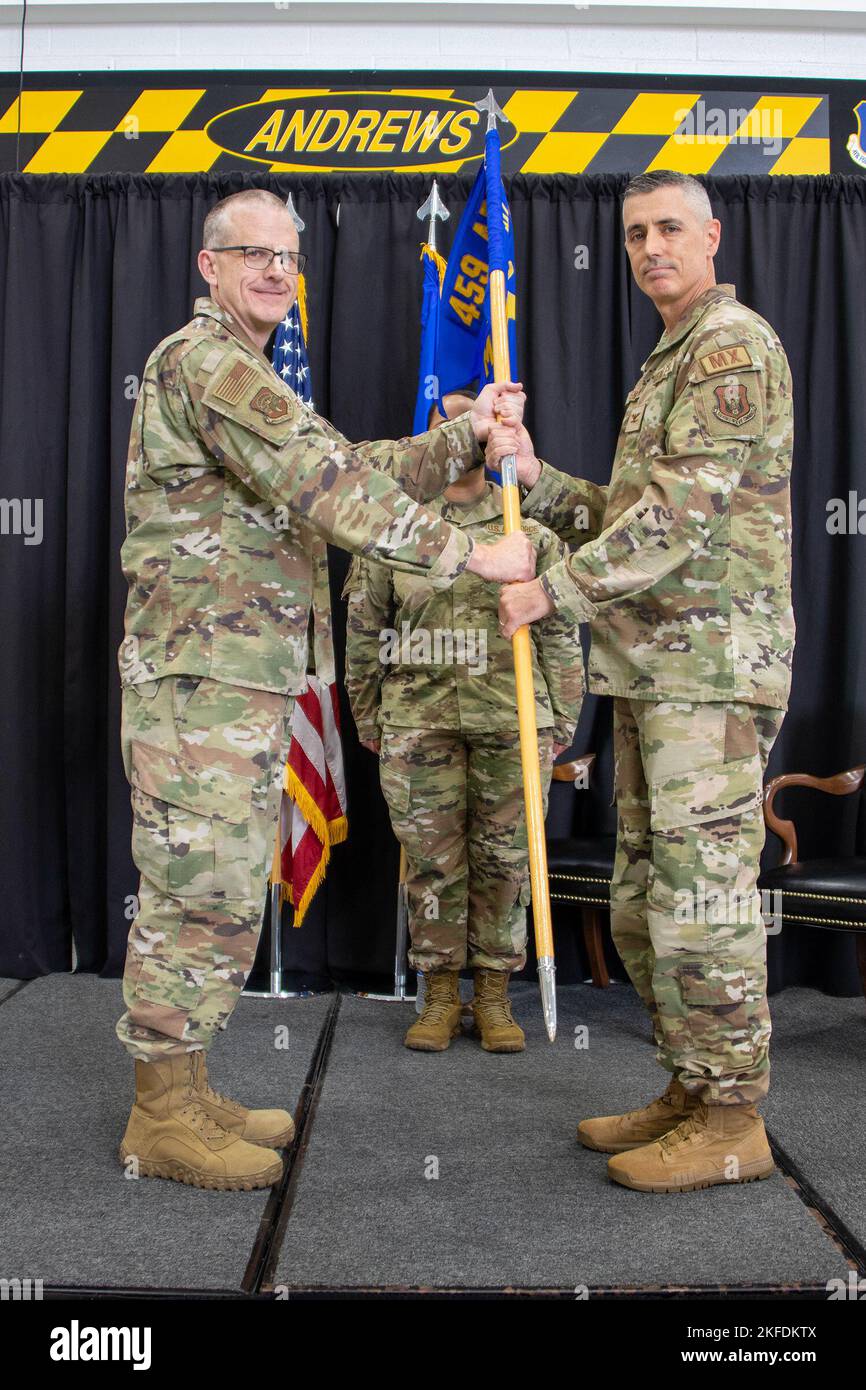 Col Kenneth Jensen (right) accepts the guidon from Col Gregory Buchanan ...