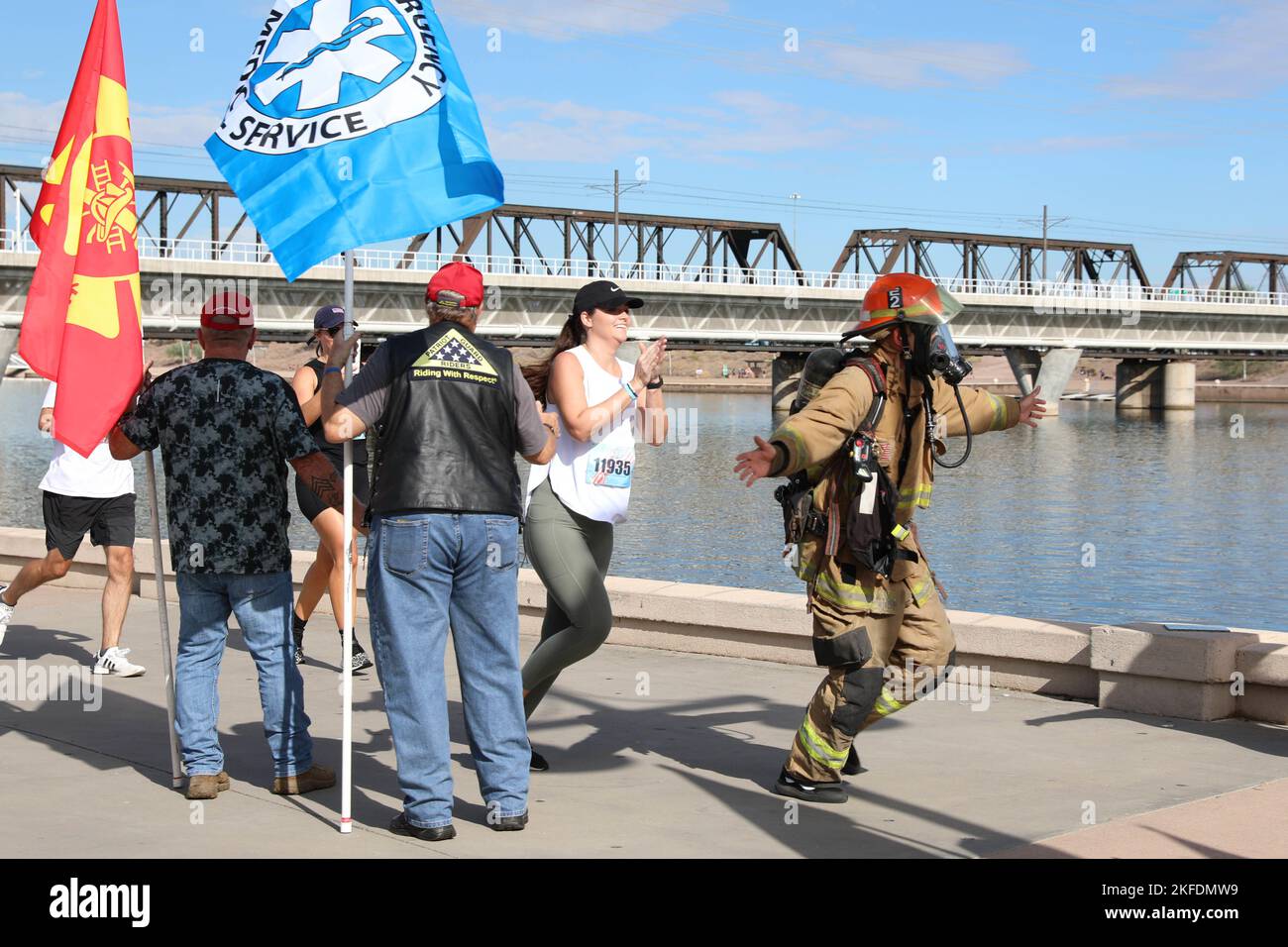 A volunteer runner wearing a fire fighting suit raced towards the ...