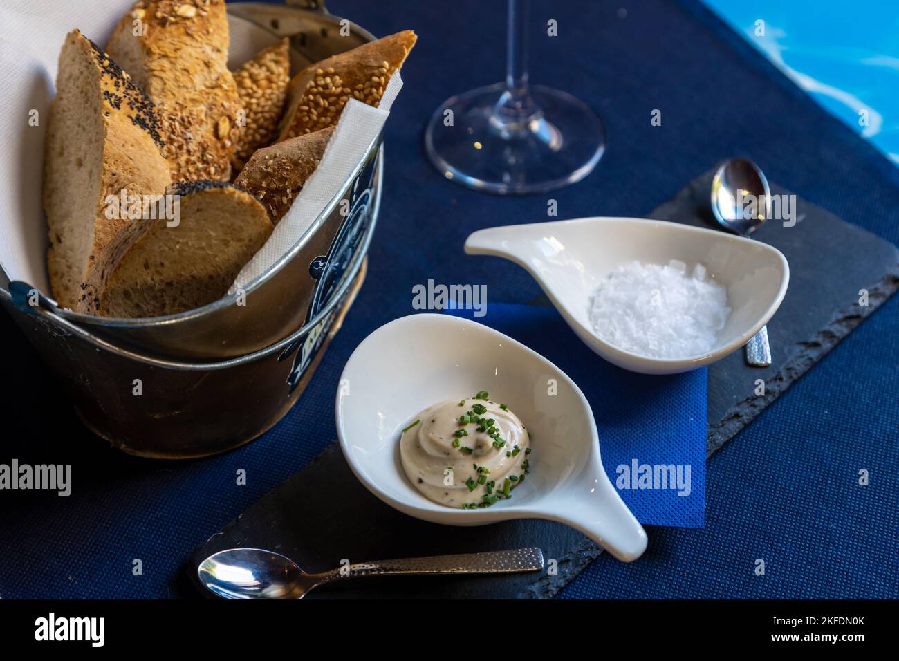 A closeup of mayonnaise and salt served on plates with bread Stock ...