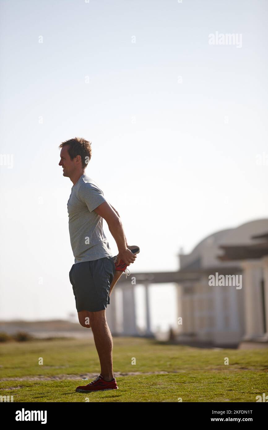 Just a quick stretch before his run. a man doing stretches before his ...