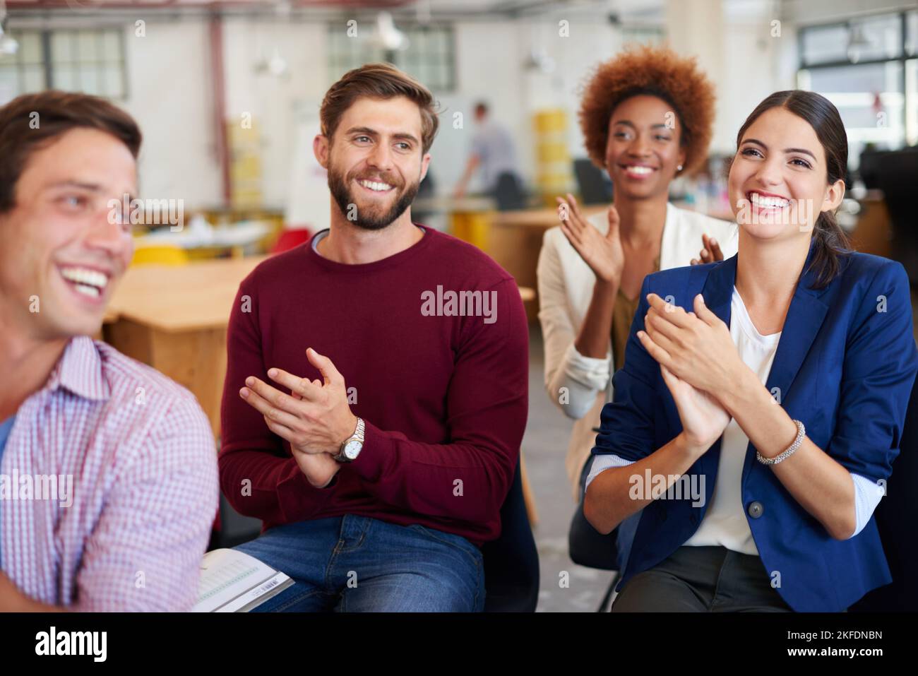 That was great. A group of colleagues applauding a work presentation ...